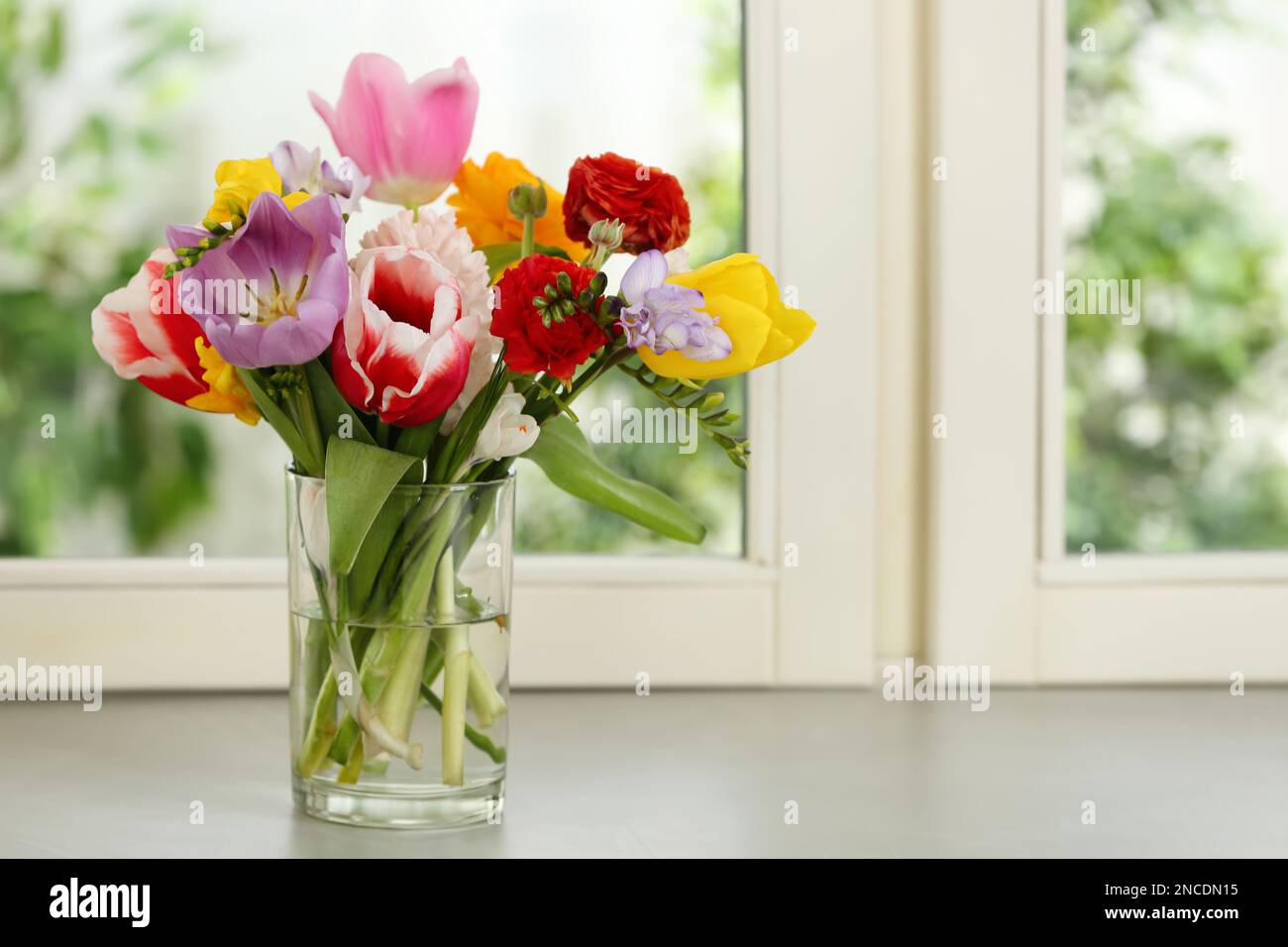 Beautiful spring flowers on window sill indoors Stock Photo - Alamy