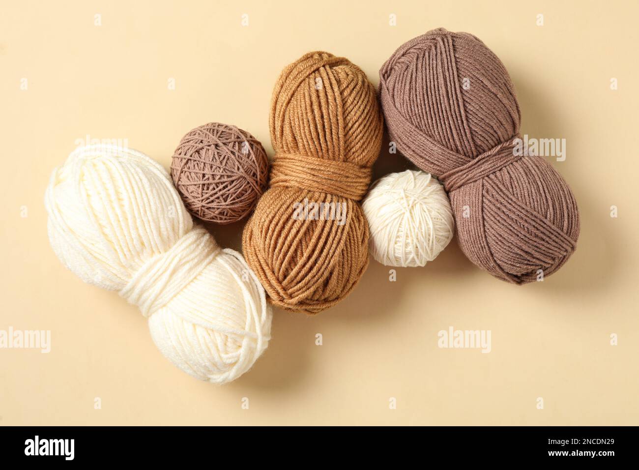 Colorful woolen yarns on beige background, flat lay Stock Photo - Alamy
