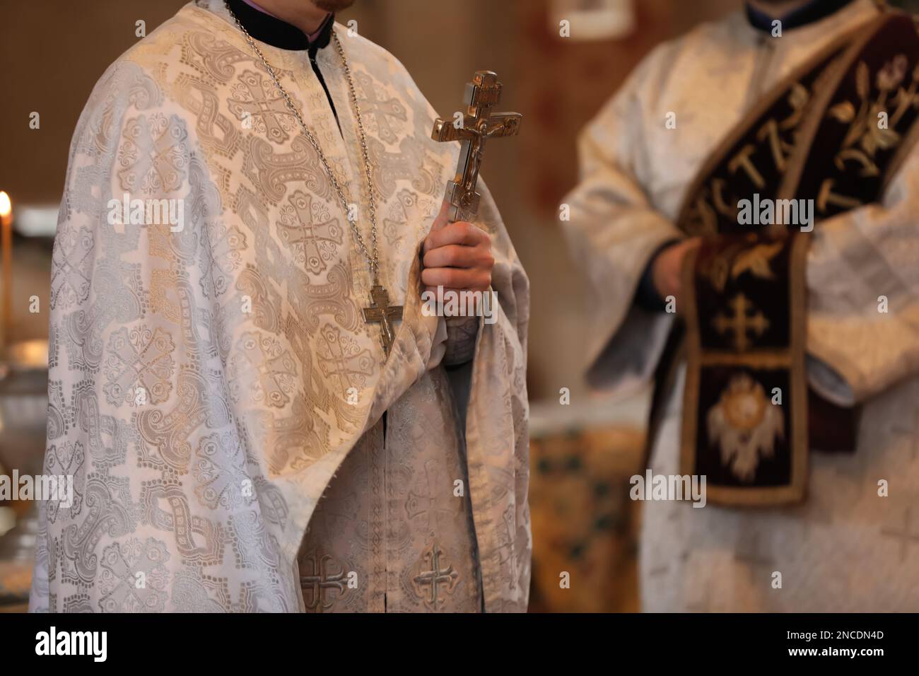 Priest with cross conducting baptism ceremony in church, closeup Stock Photo - Alamy