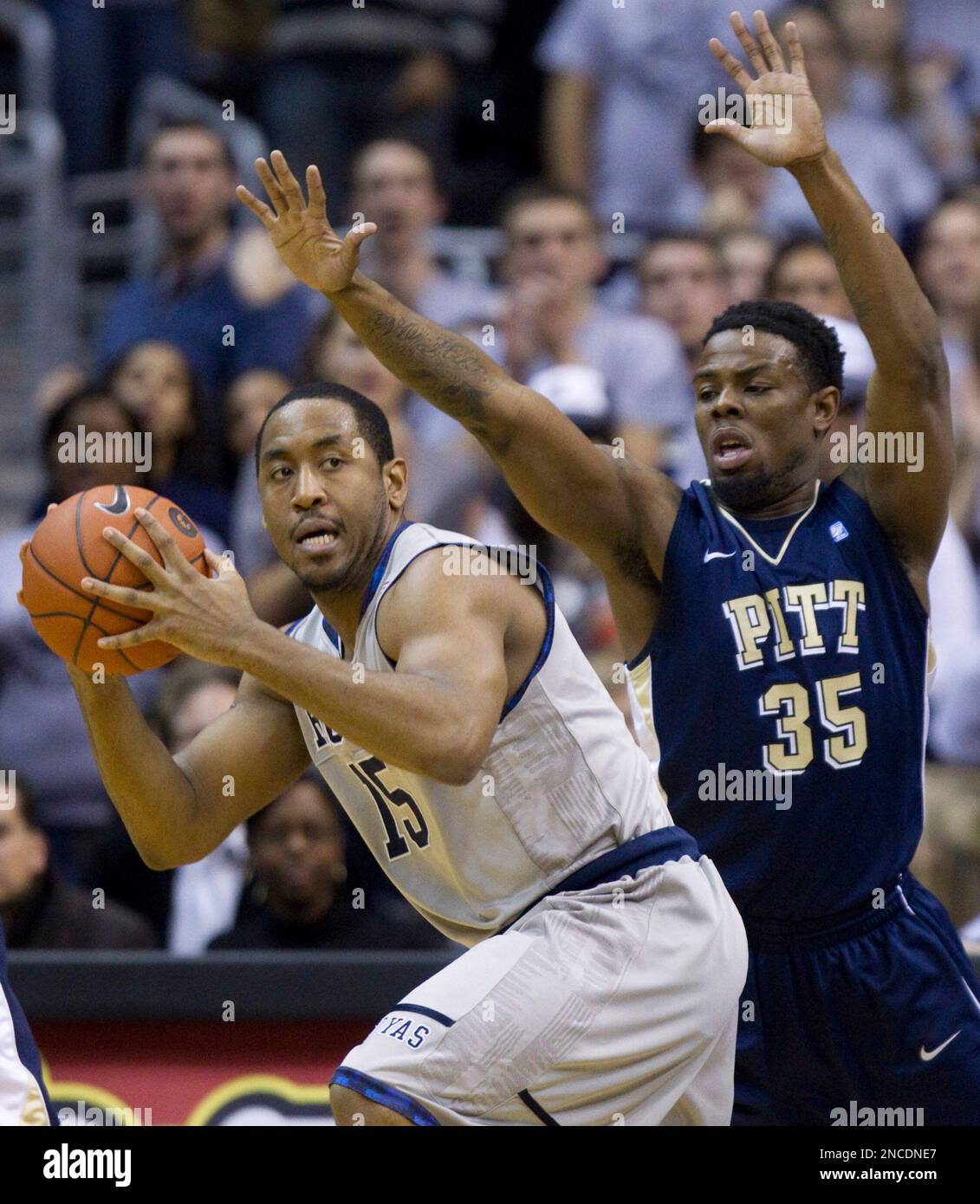 Pittsburgh forward Nasir Robinson (35) defends Georgetown guard Austin ...