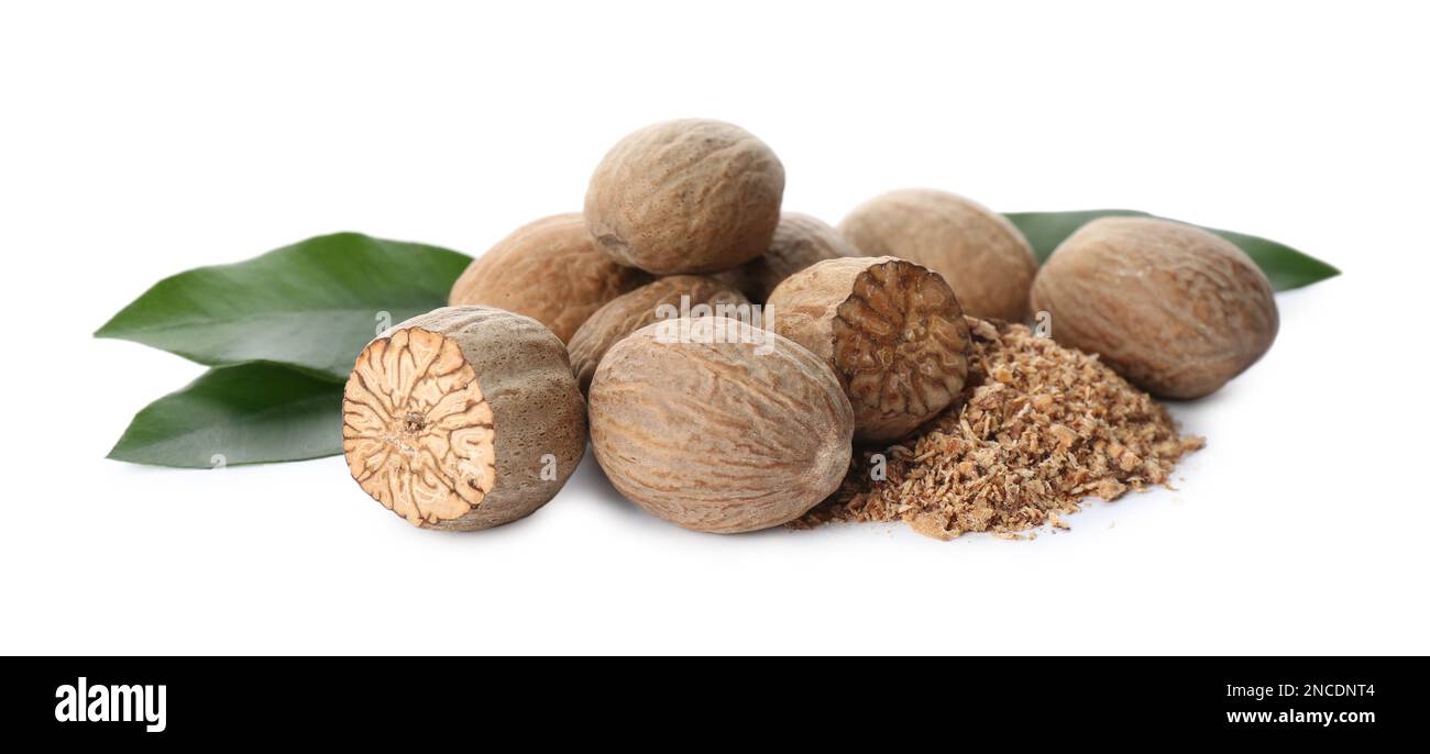 Grated nutmeg and seeds with green leaves on white background Stock ...