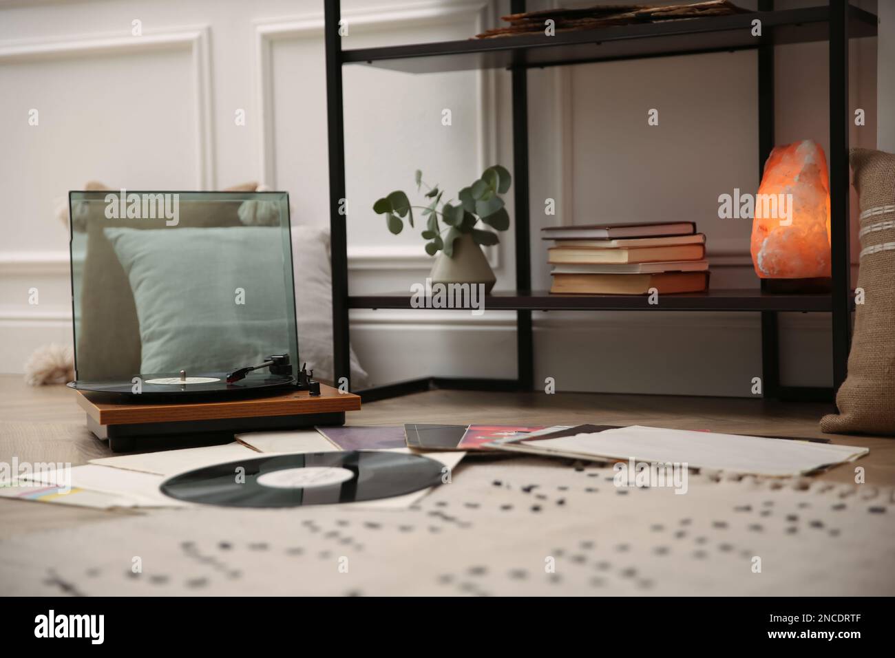 Stylish turntable with vinyl records on floor indoors Stock Photo - Alamy