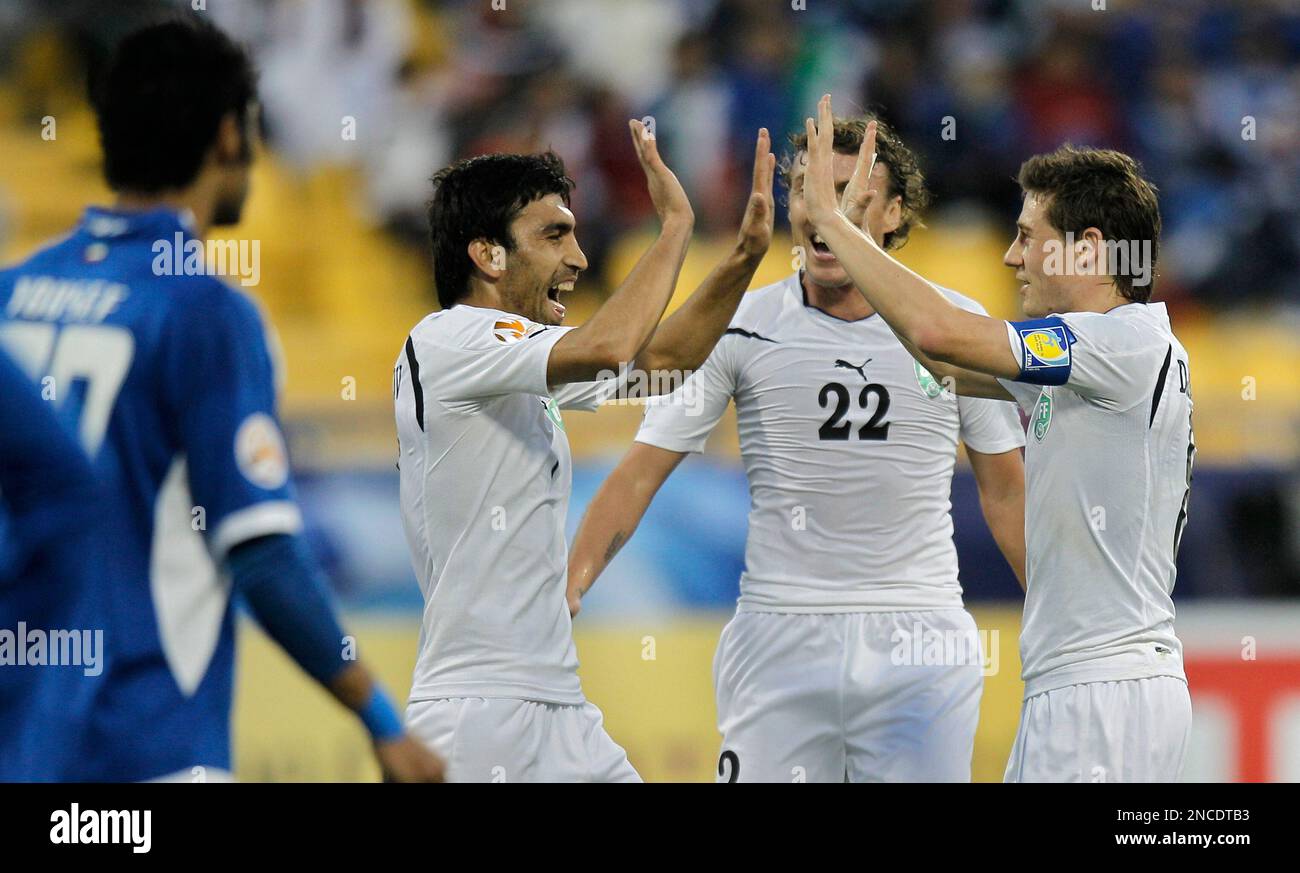 Uzbek players celebrate after scoring a goal against Kuwait during their AFC Asian Cup group A ...