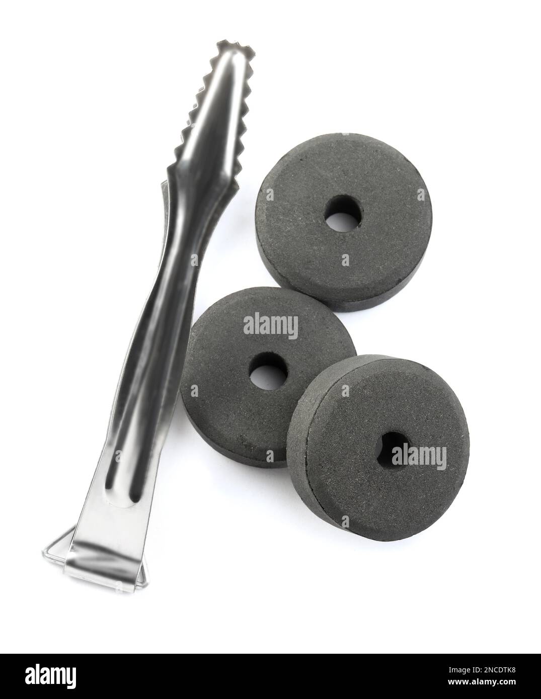 Charcoal rings for hookah and tongs on white background, top view Stock ...