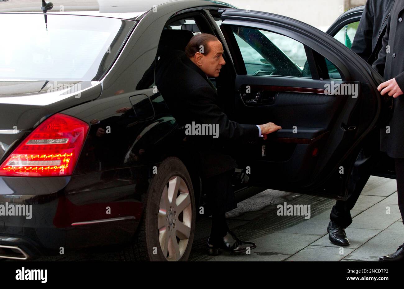 Italian Prime Minister Silvio Berlusconi steps out of a car for the ...
