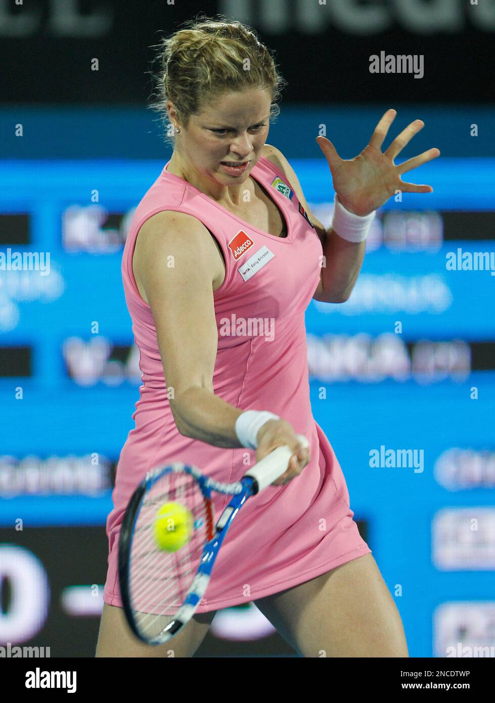 Kim Clijsters of Belgium plays a shot in her match against Victoria ...
