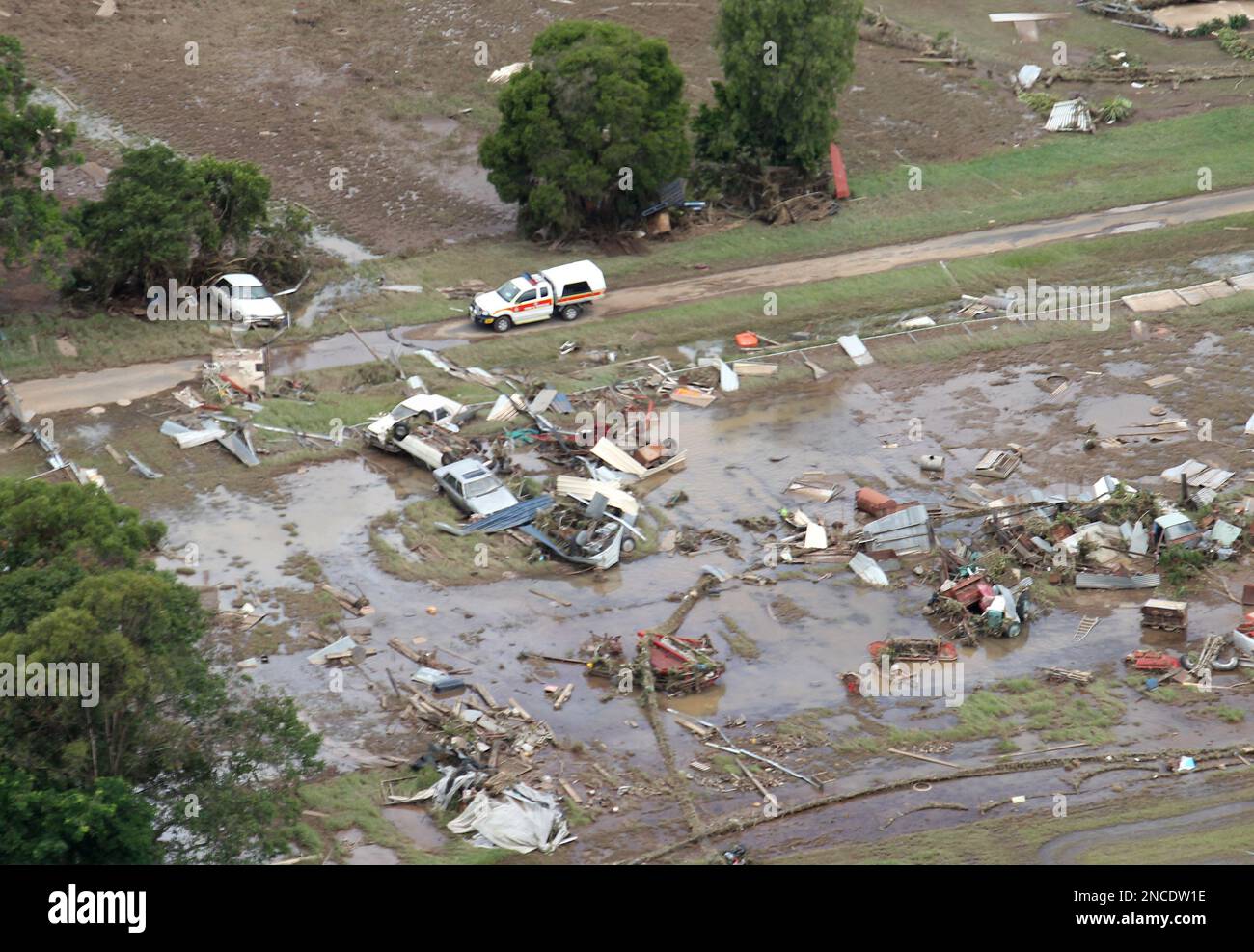 Vehicles swept away during flash flooding scatter the country side in ...