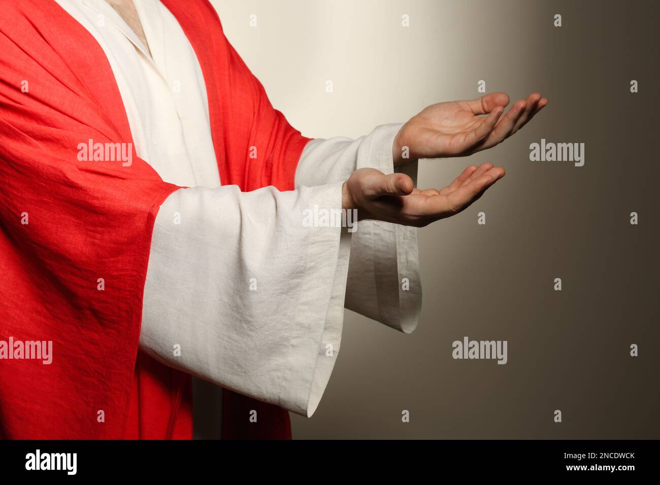 Jesus Christ reaching out his hands on beige background, closeup Stock ...