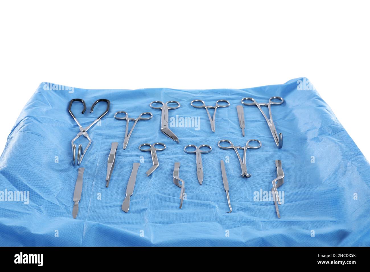 Different surgical instruments on table against light background Stock ...