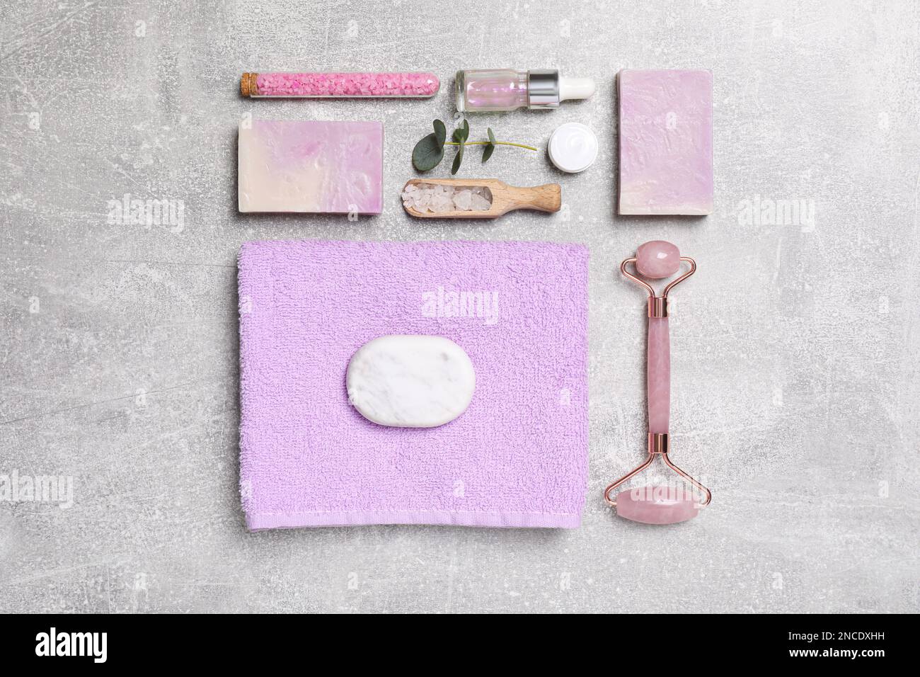 Flat lay composition with face roller and cosmetic products on light ...