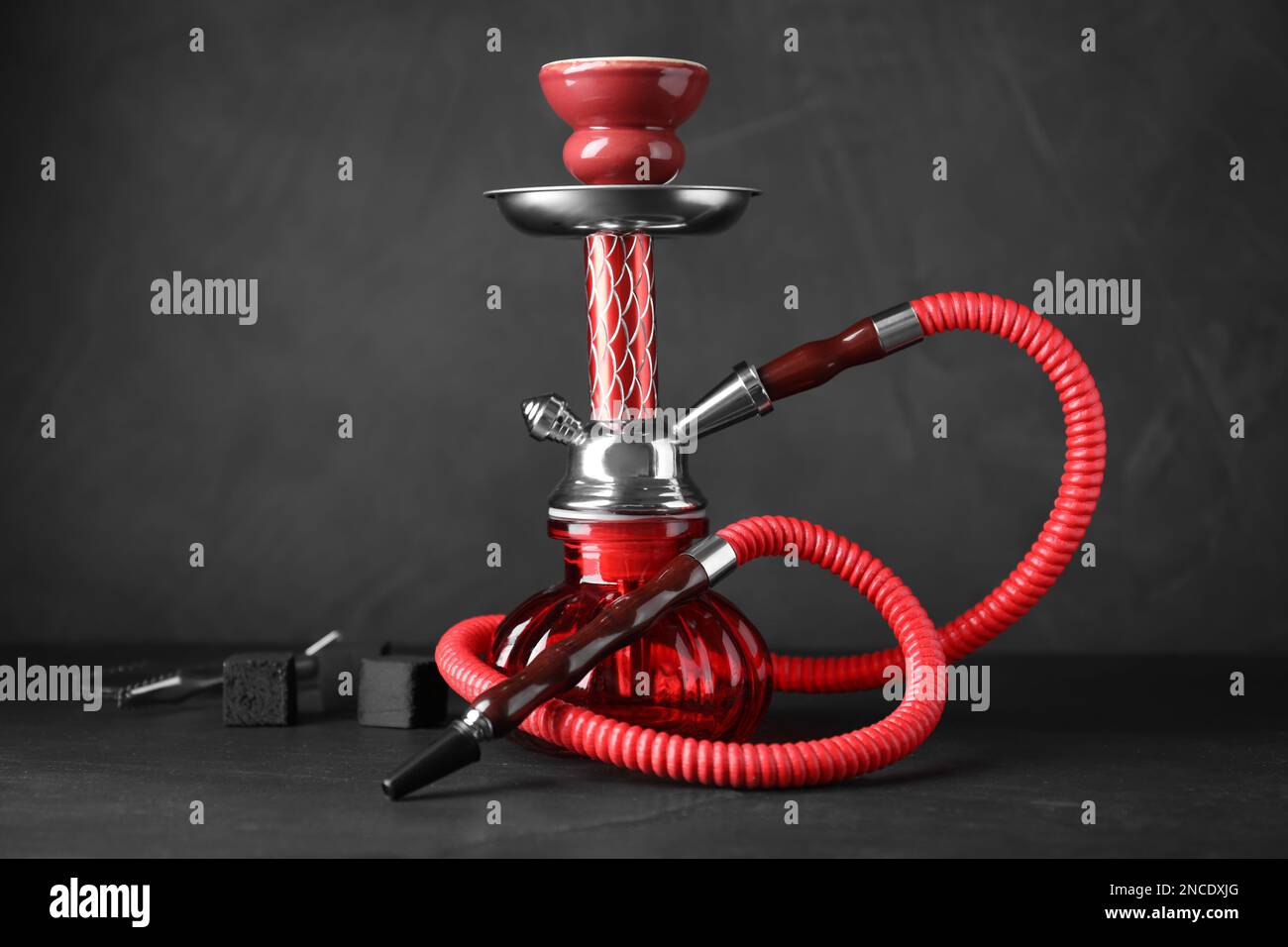 Red traditional hookah on black slate table Stock Photo - Alamy