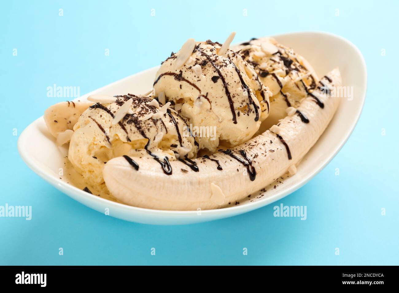 Delicious banana split ice cream with toppings on light blue background ...