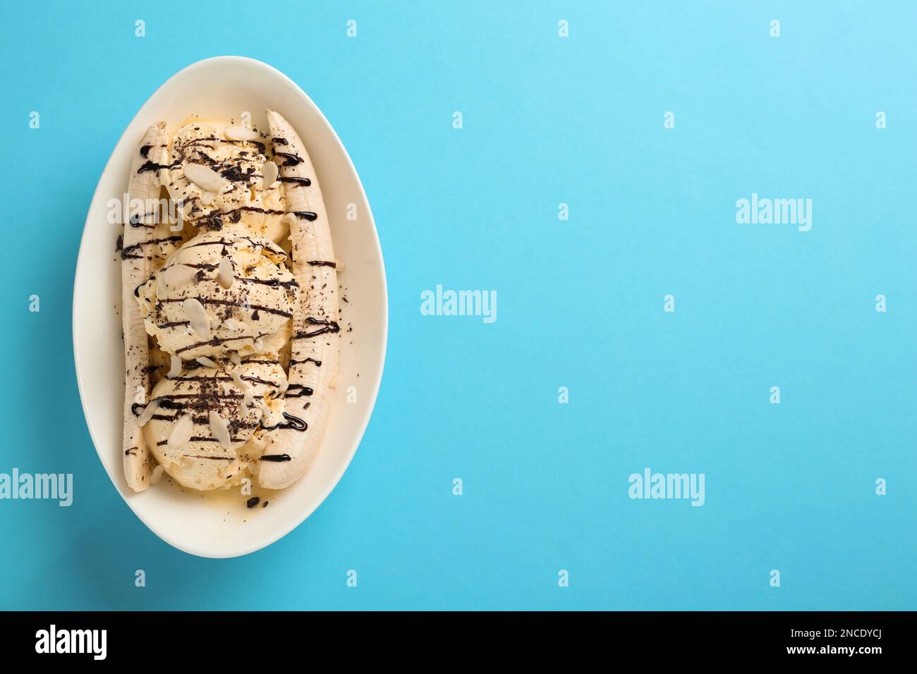 Delicious banana split ice cream with toppings on light blue background ...