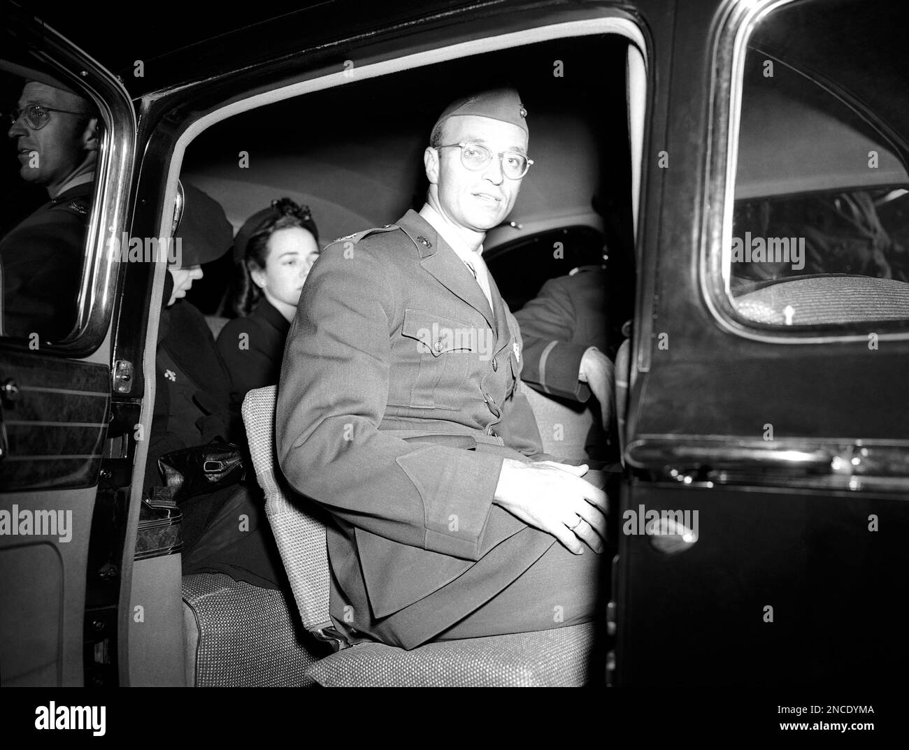 Marine Col. James Roosevelt sits in a car on his way to the White House ...