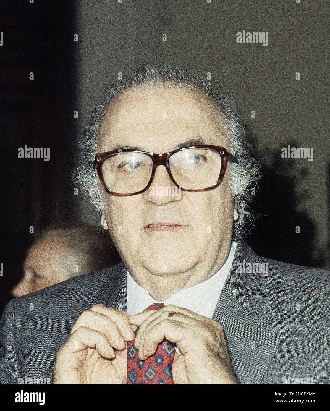 Italian film director Federico Fellini adjust his tie in 1986 in Rome ...