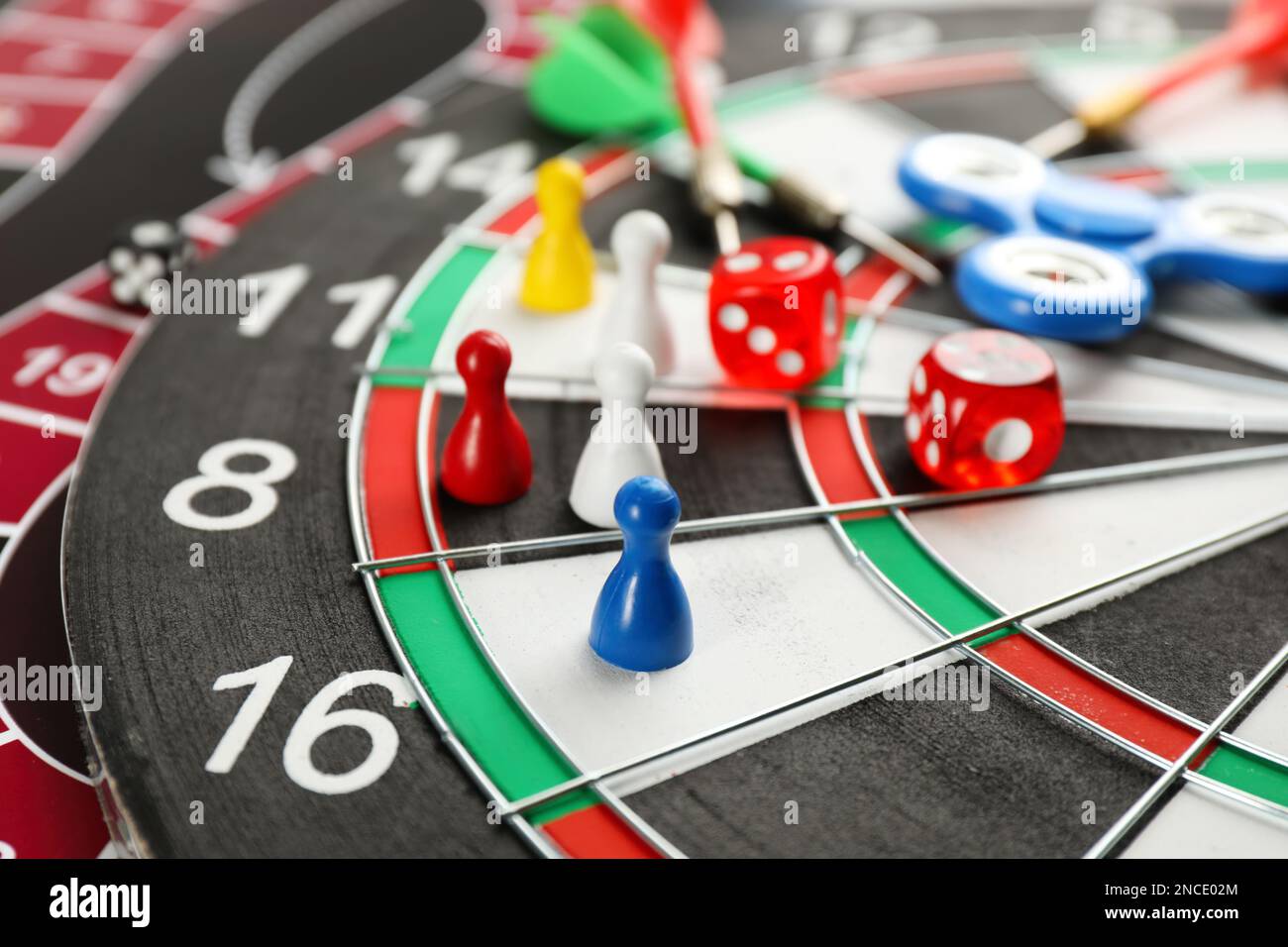 Components of tabletop games on dart board, closeup Stock Photo - Alamy