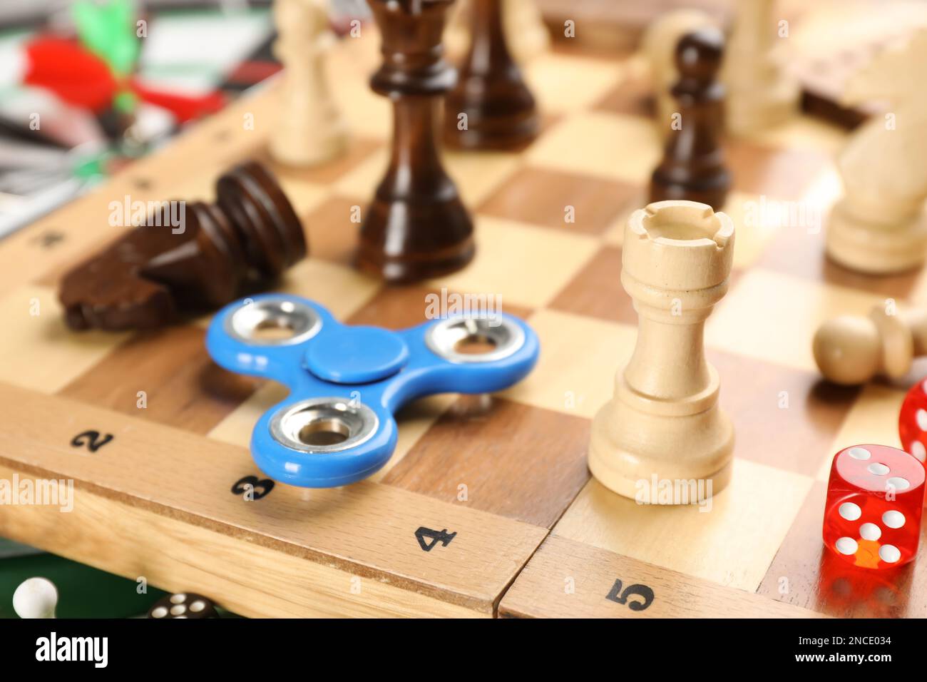 Spinner, pieces and dices on chess board, closeup. Tabletop games Stock ...