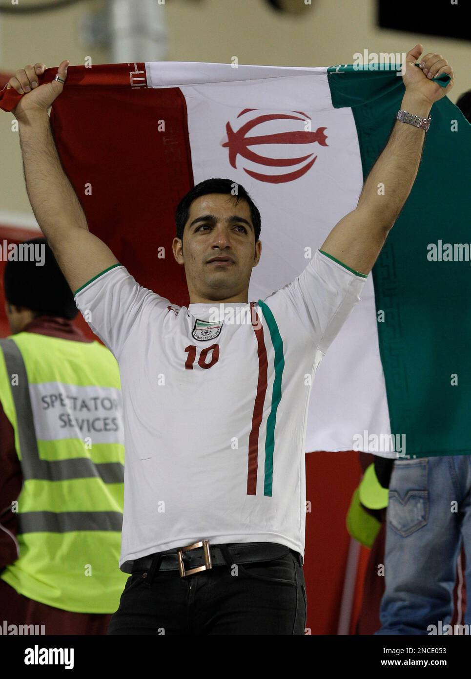 An Iranian fan, waves by his national flag during the AFC Asian Cup ...