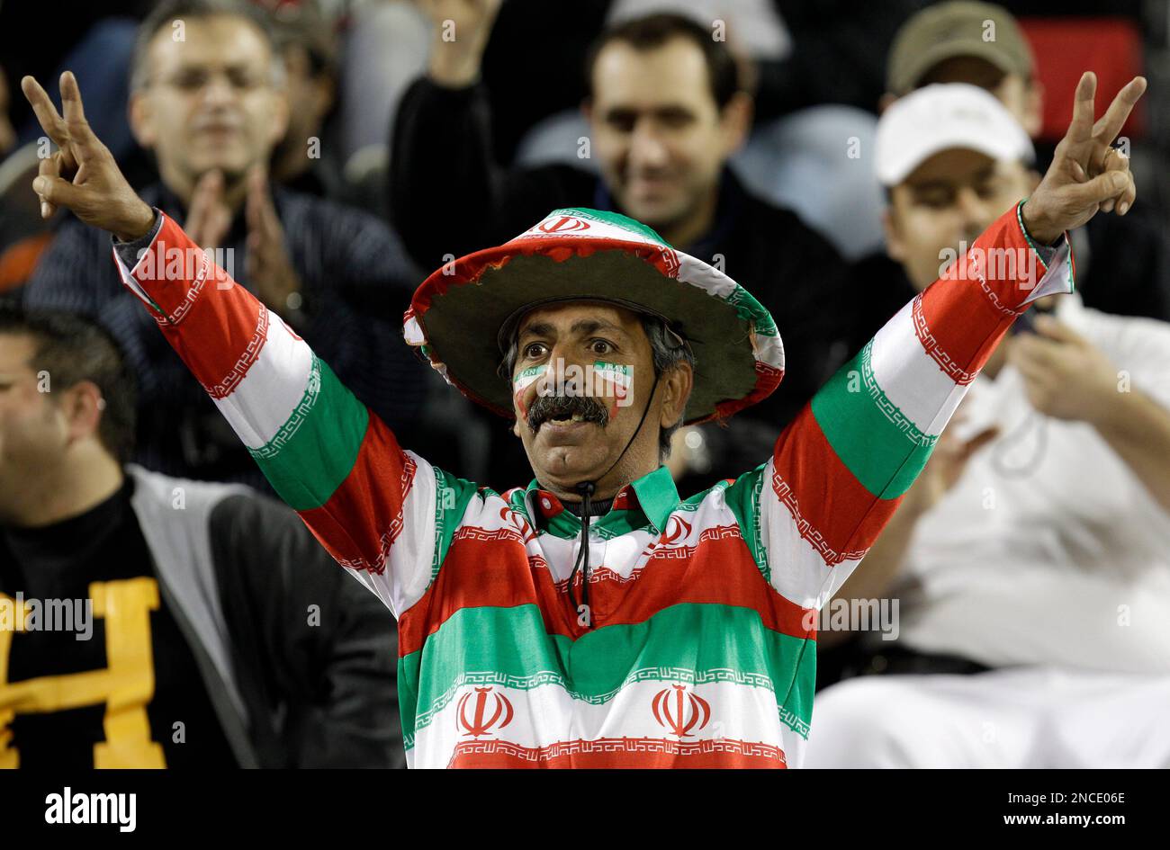 An Iranian fan, cheers as he waves Victory V-signs during the AFC Asian ...
