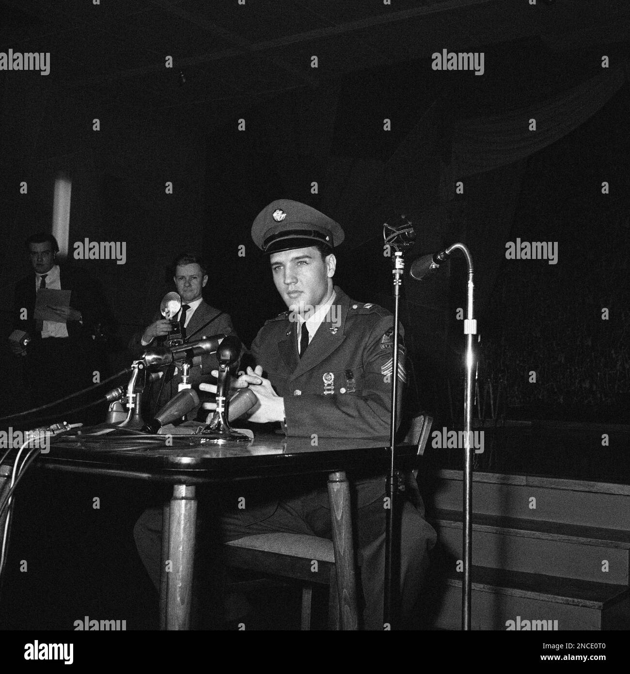 Elvis Presley, who flies home to get out of the army holds a press ...