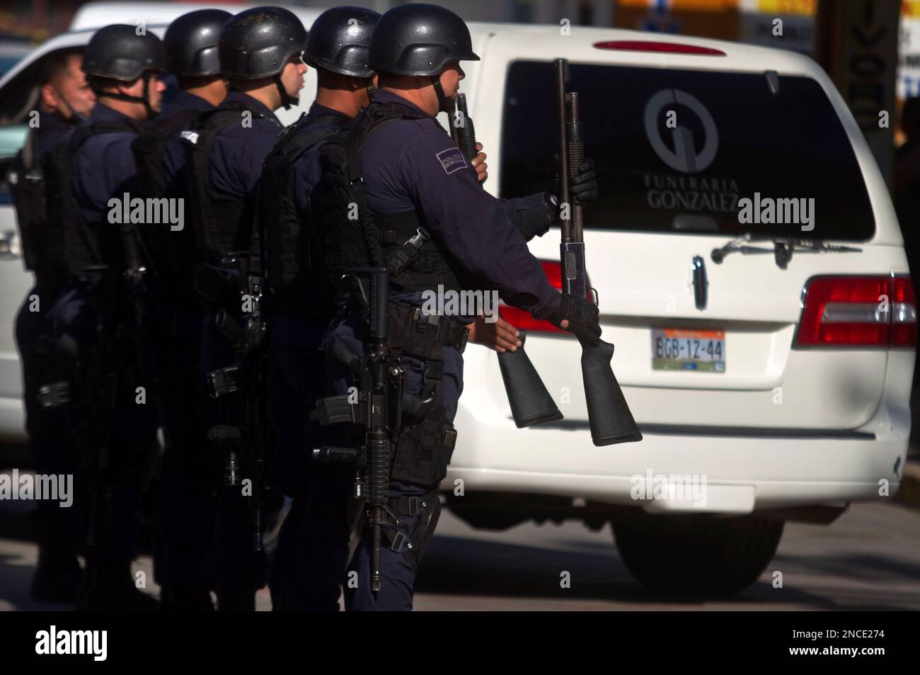 A Tijuana police honor guard standby as the hearse carrying state ...