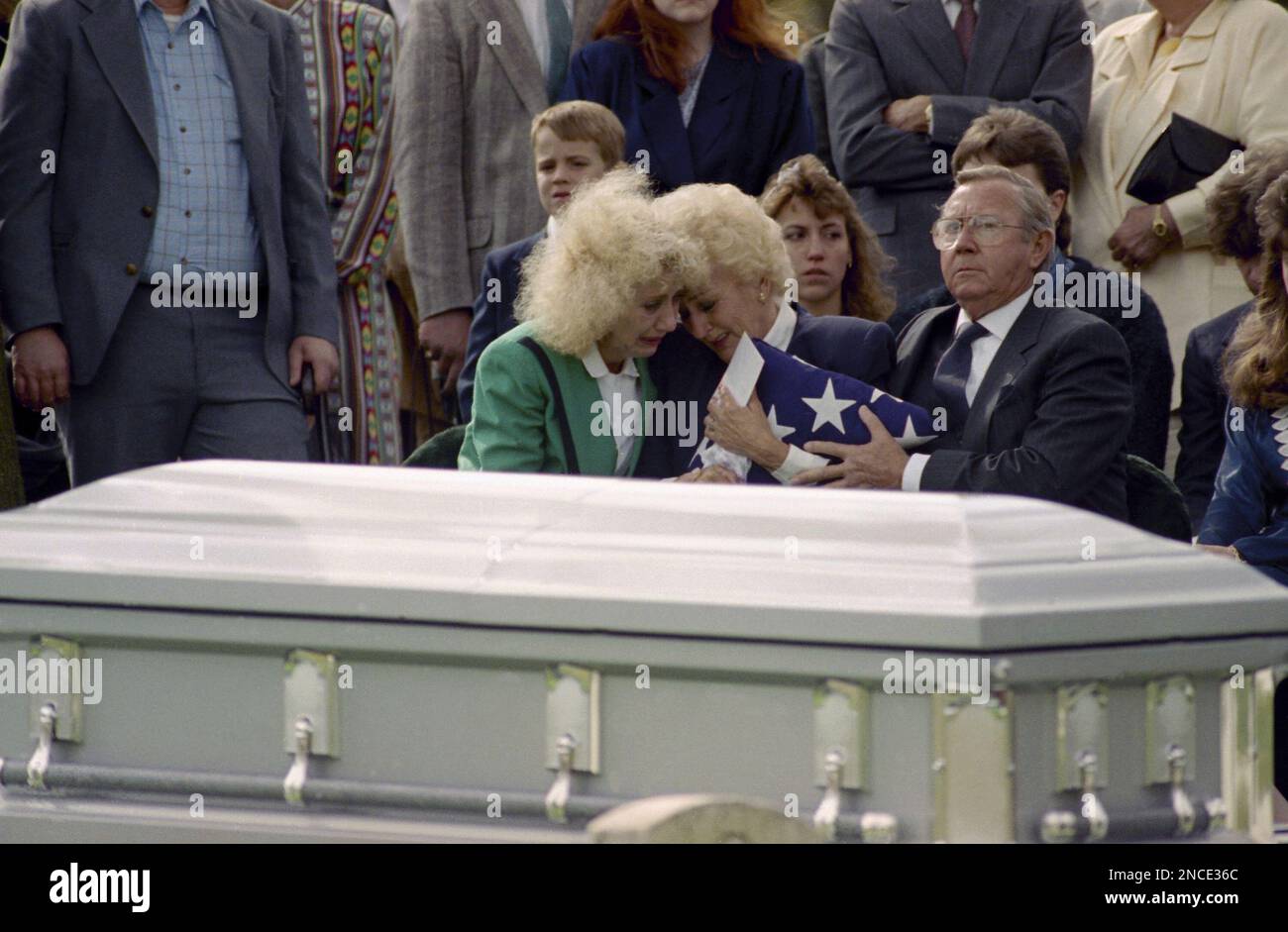 Mrs. Wilma Vanden Eykel, center, clutches a flag that was presented ...