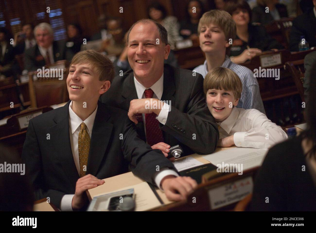 State Rep. Mike Dudgeon, second from left, casts the ceremonial first ...