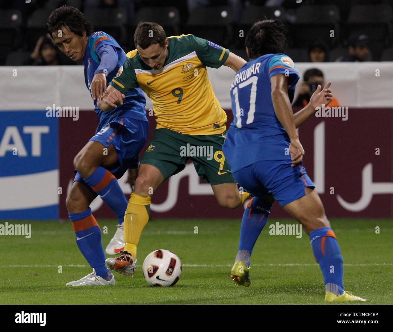 Australia's Scott McDonald, center, fights for ball against two Indian ...