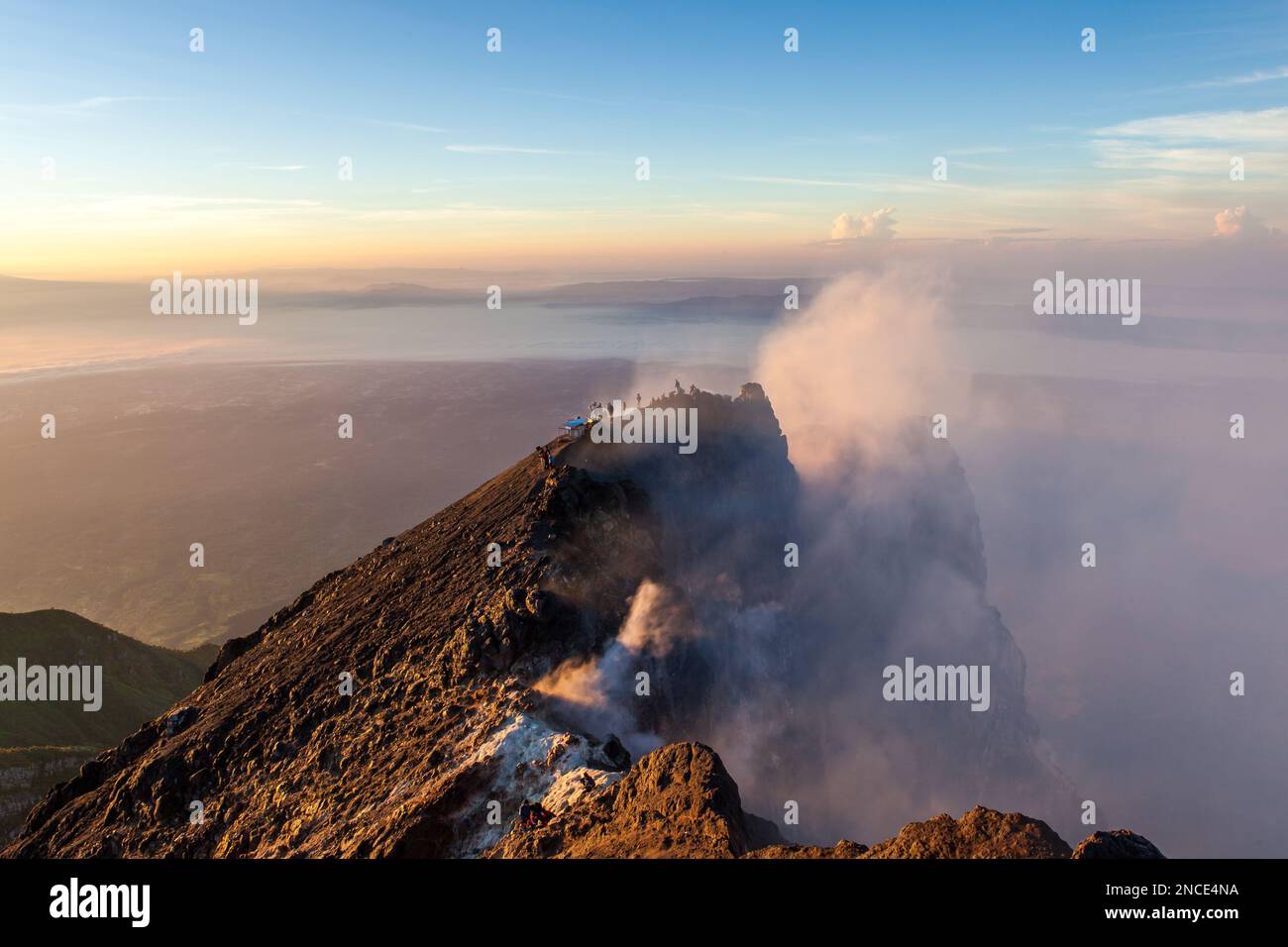 Merapi volcano crater rim with people at sunrise Stock Photo - Alamy