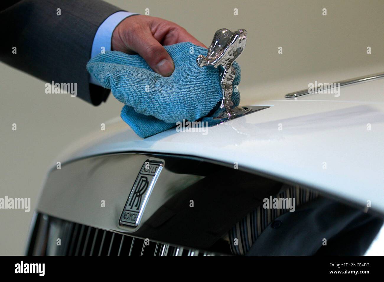 Sales coordinator Neil Solanki cleans the "Spirit of Ecstasy" hood ...