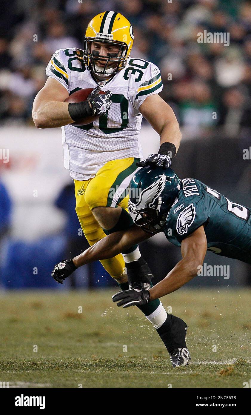 Green Bay Packers fullback John Kuhn pushes off of the helmet of ...