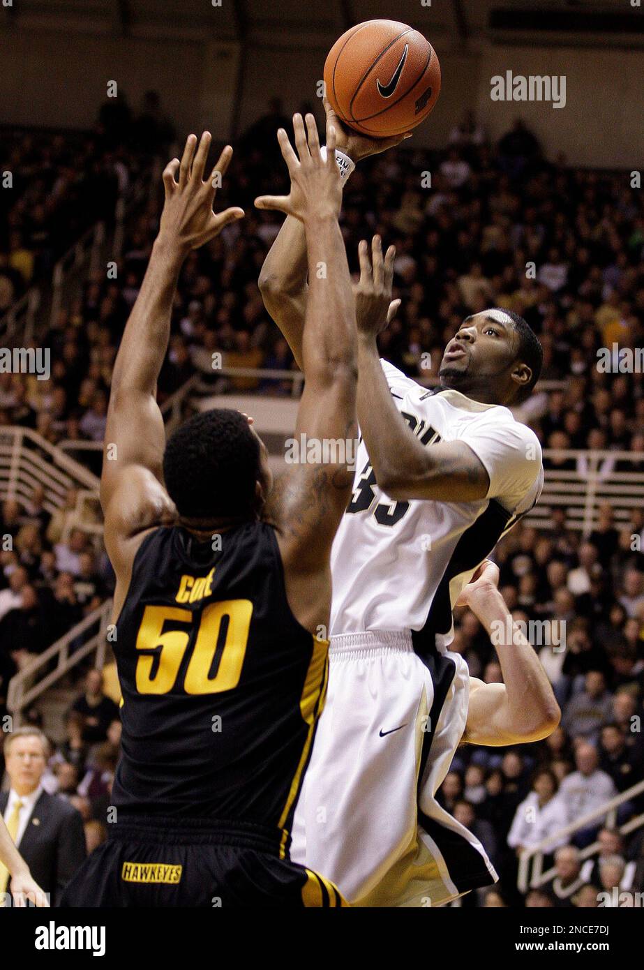 Purdue guard E'Twaun Moore, right, shoots over Iowa forward Jarryd Cole ...