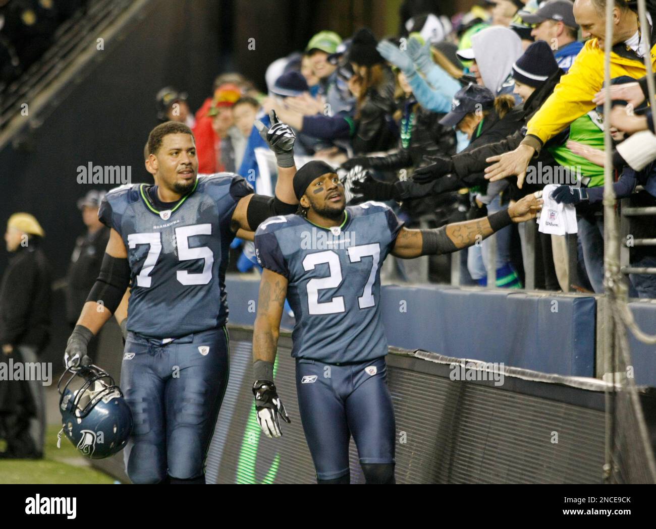 Seattle Seahawks' Jordan Babineaux (27) and Sean Locklear (75) greet ...