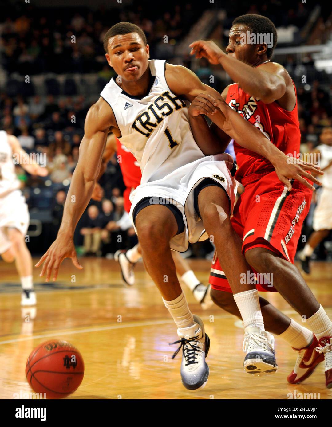 Notre Dame forward Tyrone Nash, left, drives the lane as St John's ...