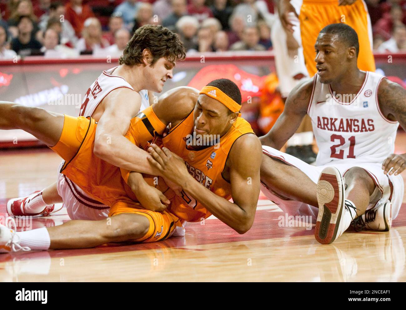 Arkansas forward Michael Sanchez (31) and Tennessee forward John Fields ...