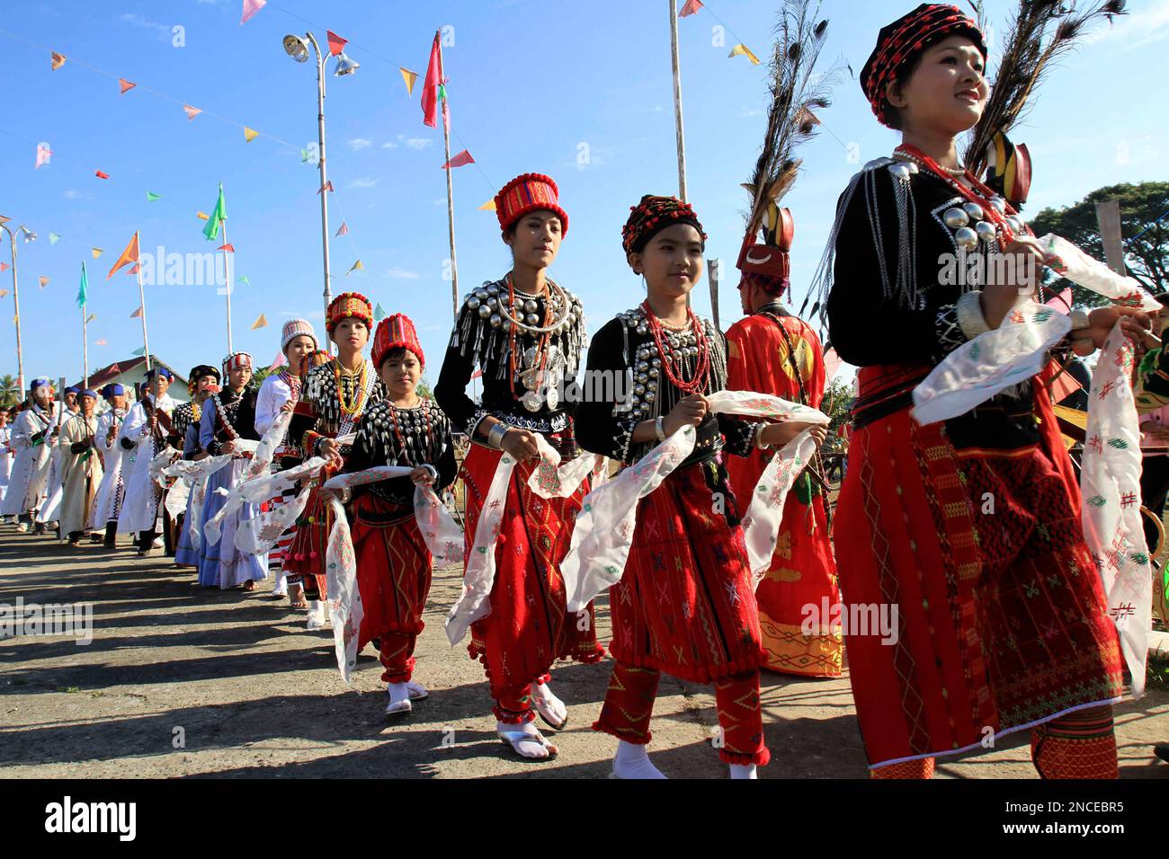 Clad in traditional dress, ethnic Kachin people dance during their ...