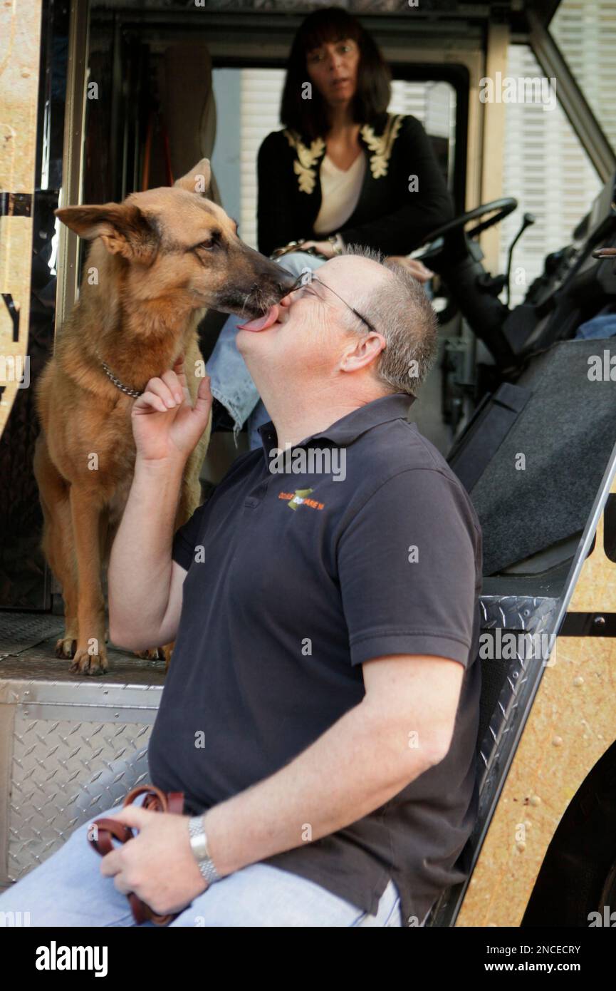 Double Dog Dare Ya kennel owner Patrick Guilfoyle gets a kiss from his ...