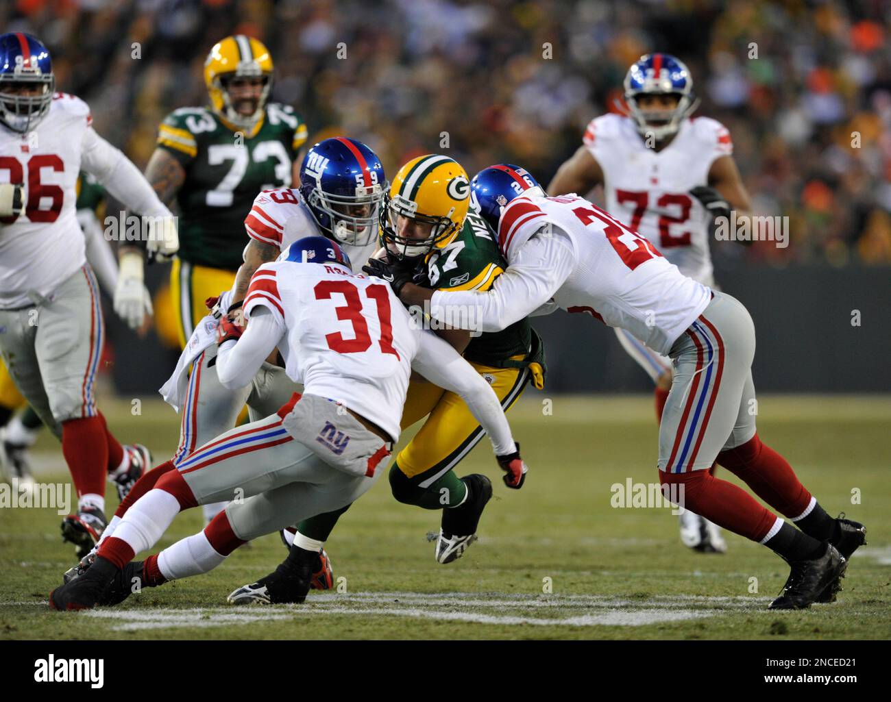 New York Giants' Aaron Ross (31) and Antrel Rolle (26) apply pressure ...