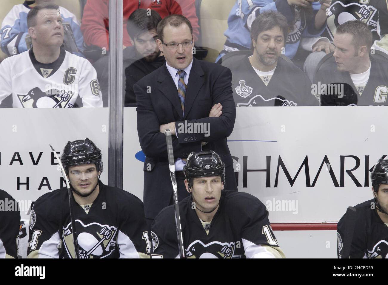 Pittsburgh Penguins coach Dan Bylsma stands behind his bench during the ...