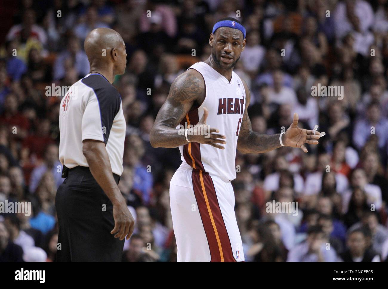 Referee Tom Washington, left, talks with Miami Heat's LeBron James (6 ...