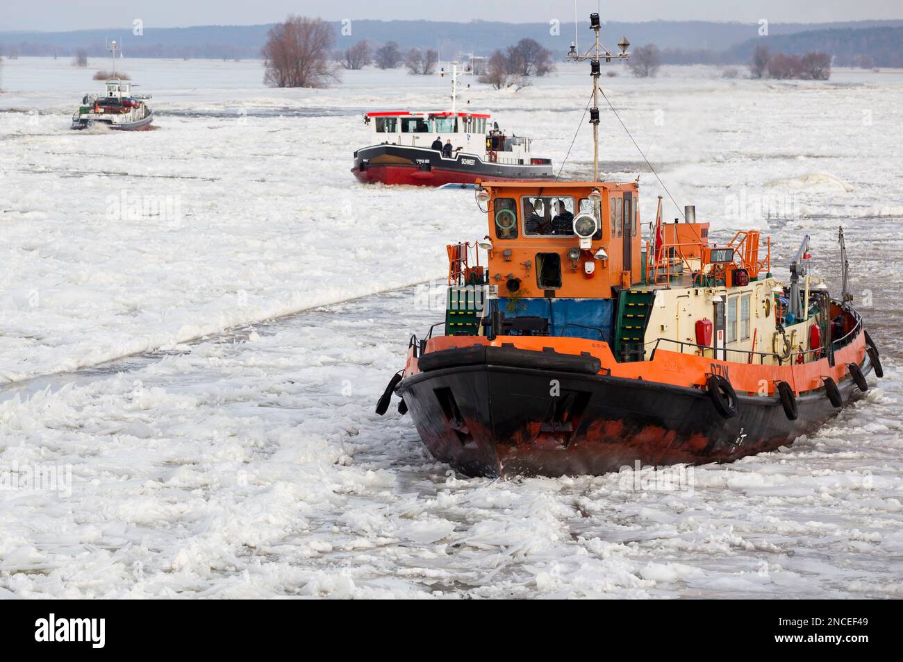 Ice-breakers crush the ice on the frozen river Oder at the border ...