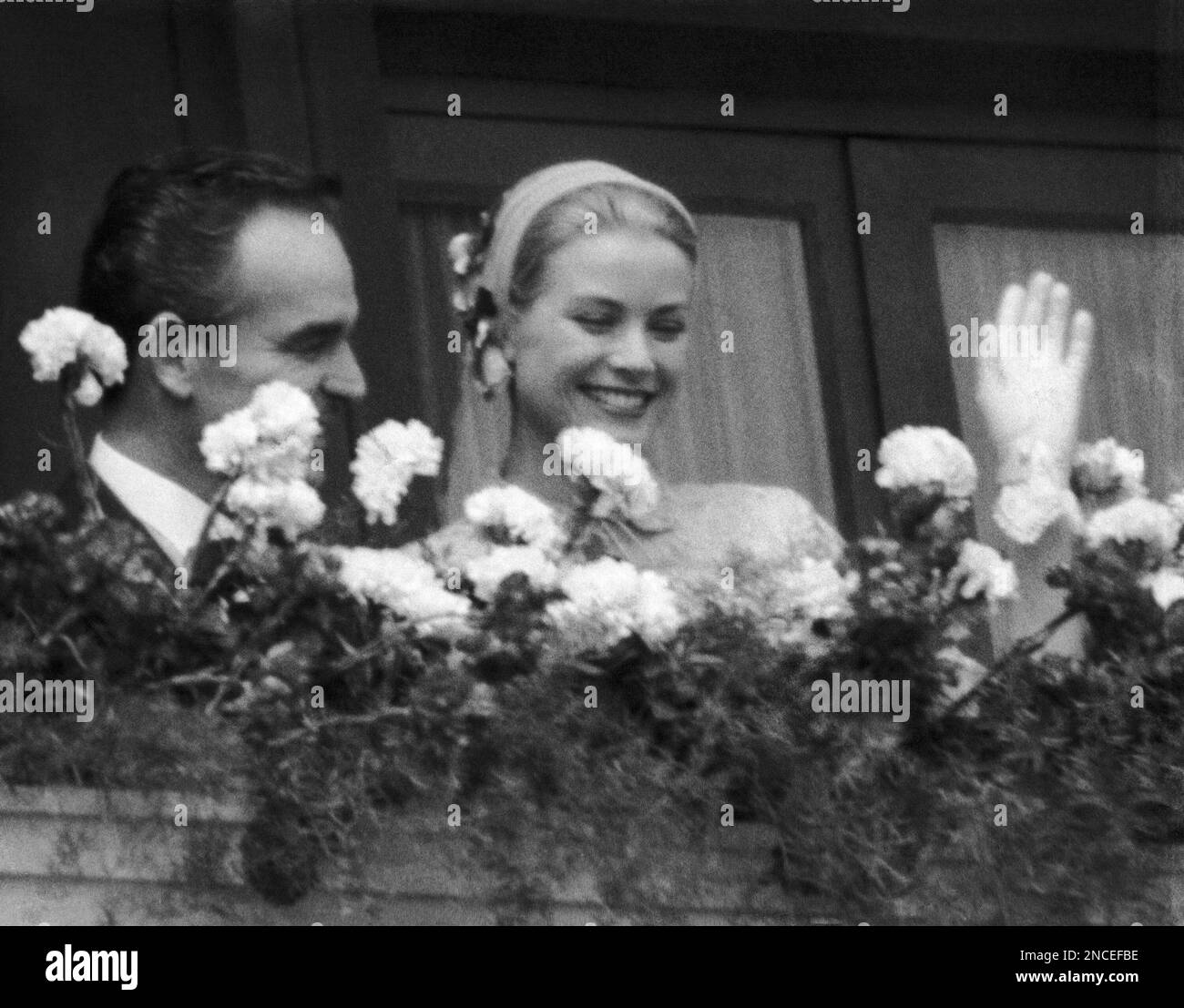 Grace Kelly and Prince Rainier III wave from a palace balcony after the ...