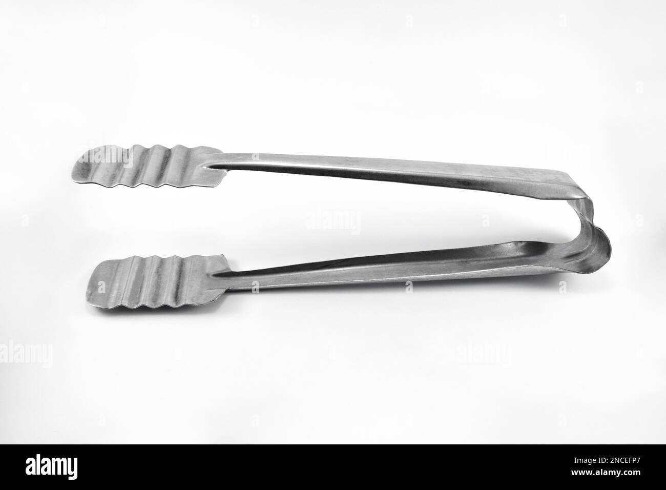 Stainless steel food tongs isolated on white background. Serving ...