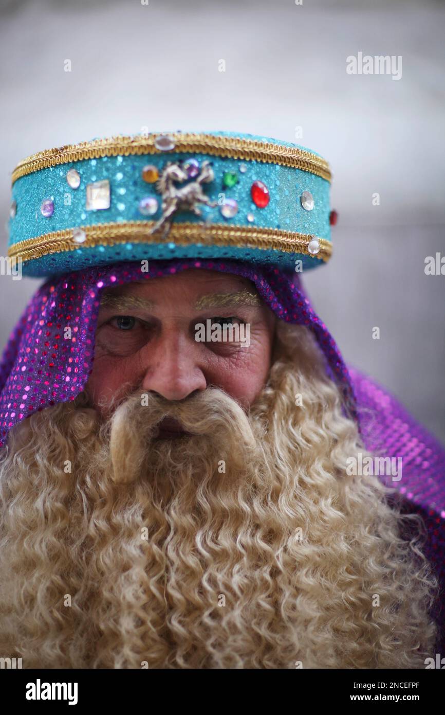 A man, dressed as one of the Three Kings, poses for a photo during the ...