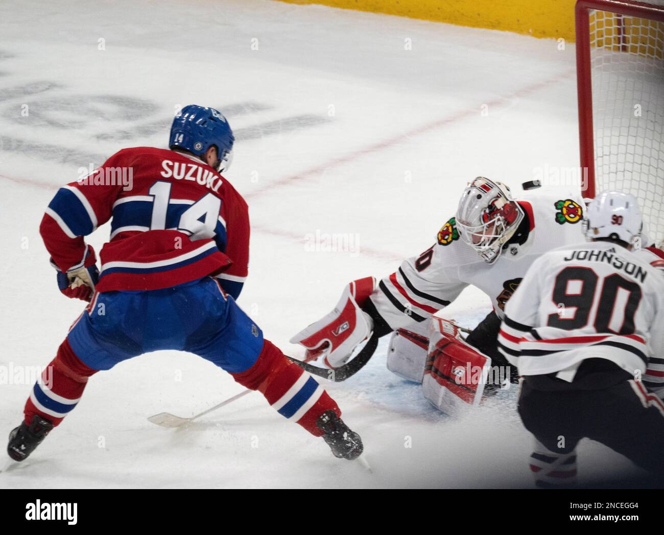 Montreal Canadiens' Nick Suzuki (14) is stopped by Chicago Blackhawks ...