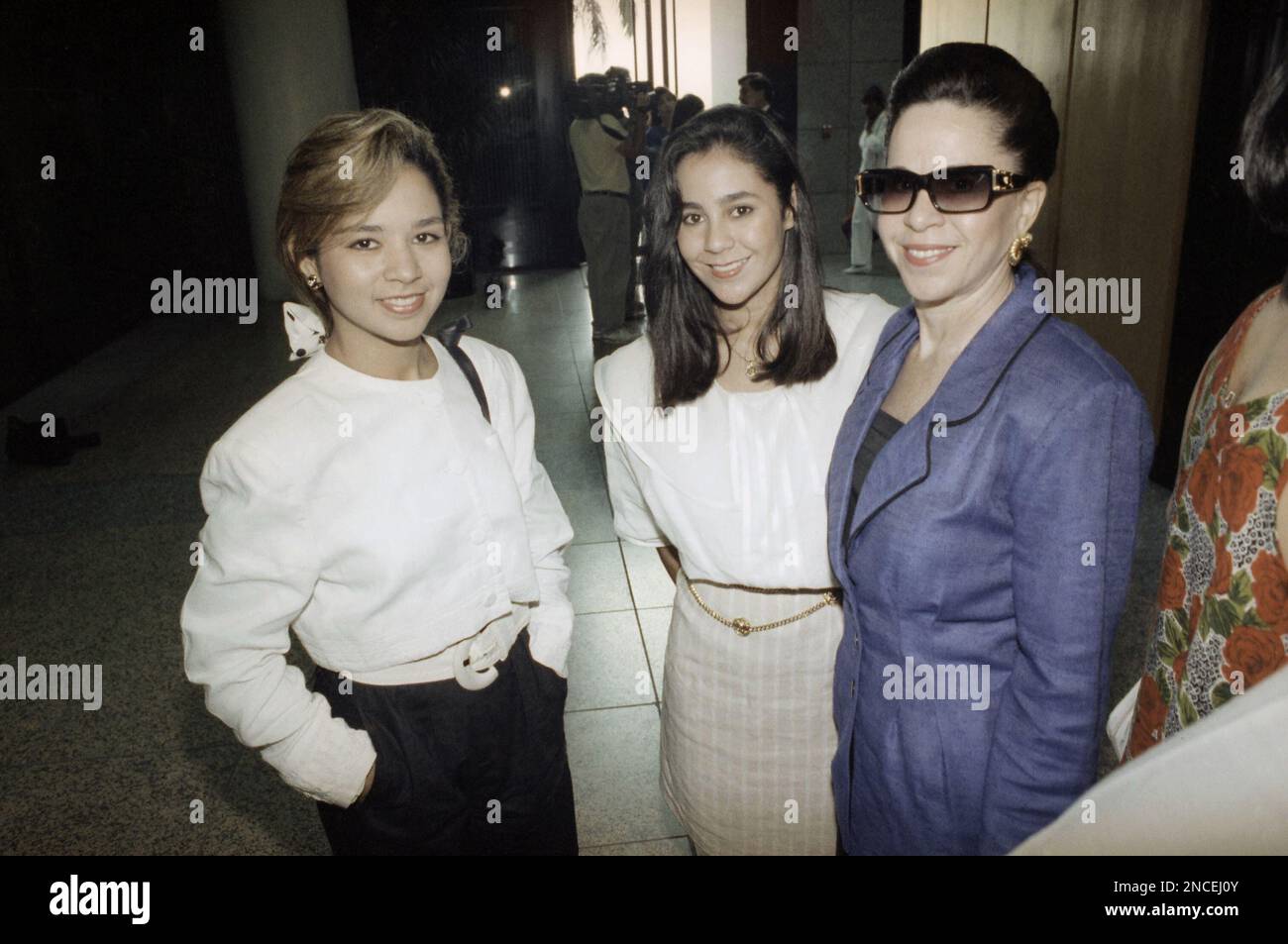 The family of Manuel Noriega stops and pauses for photographers in a ...