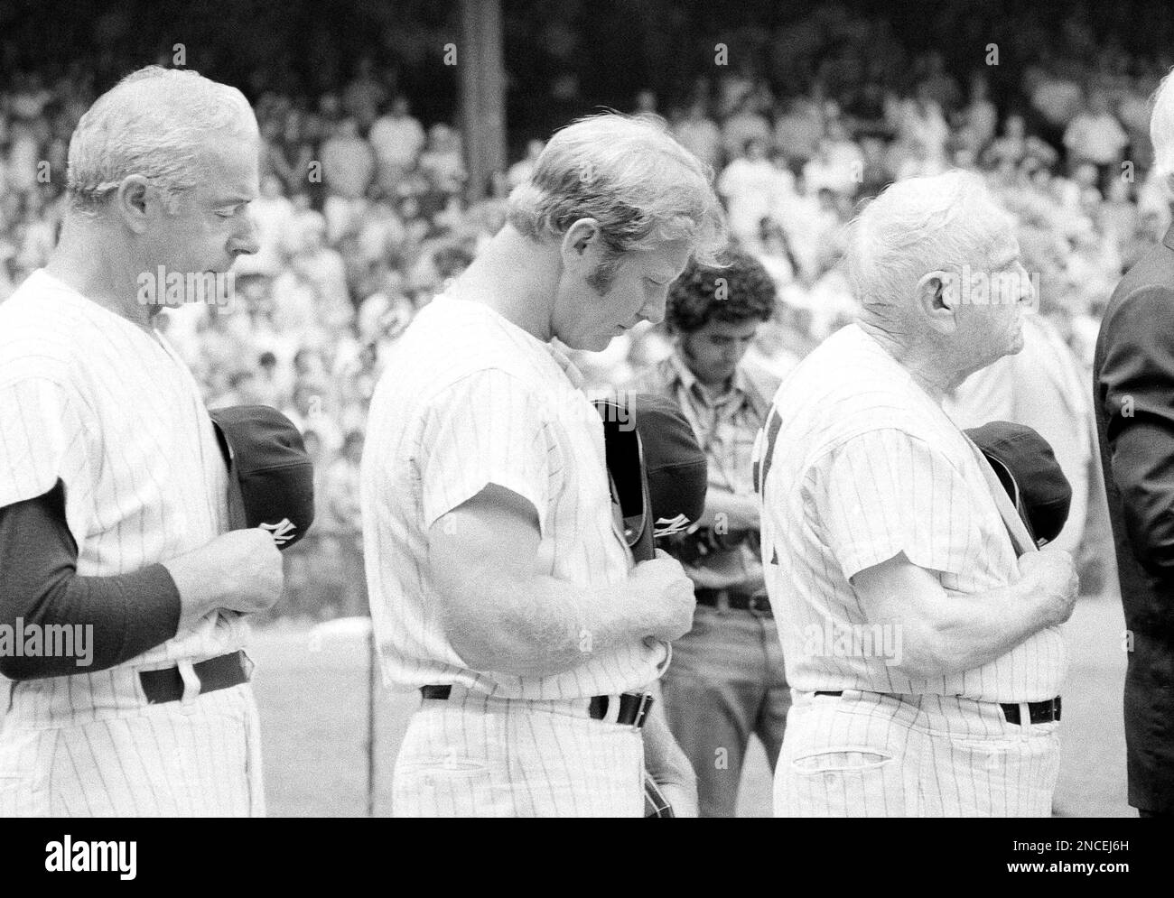 Three New York Yankee greats bow their head in respect during the ...