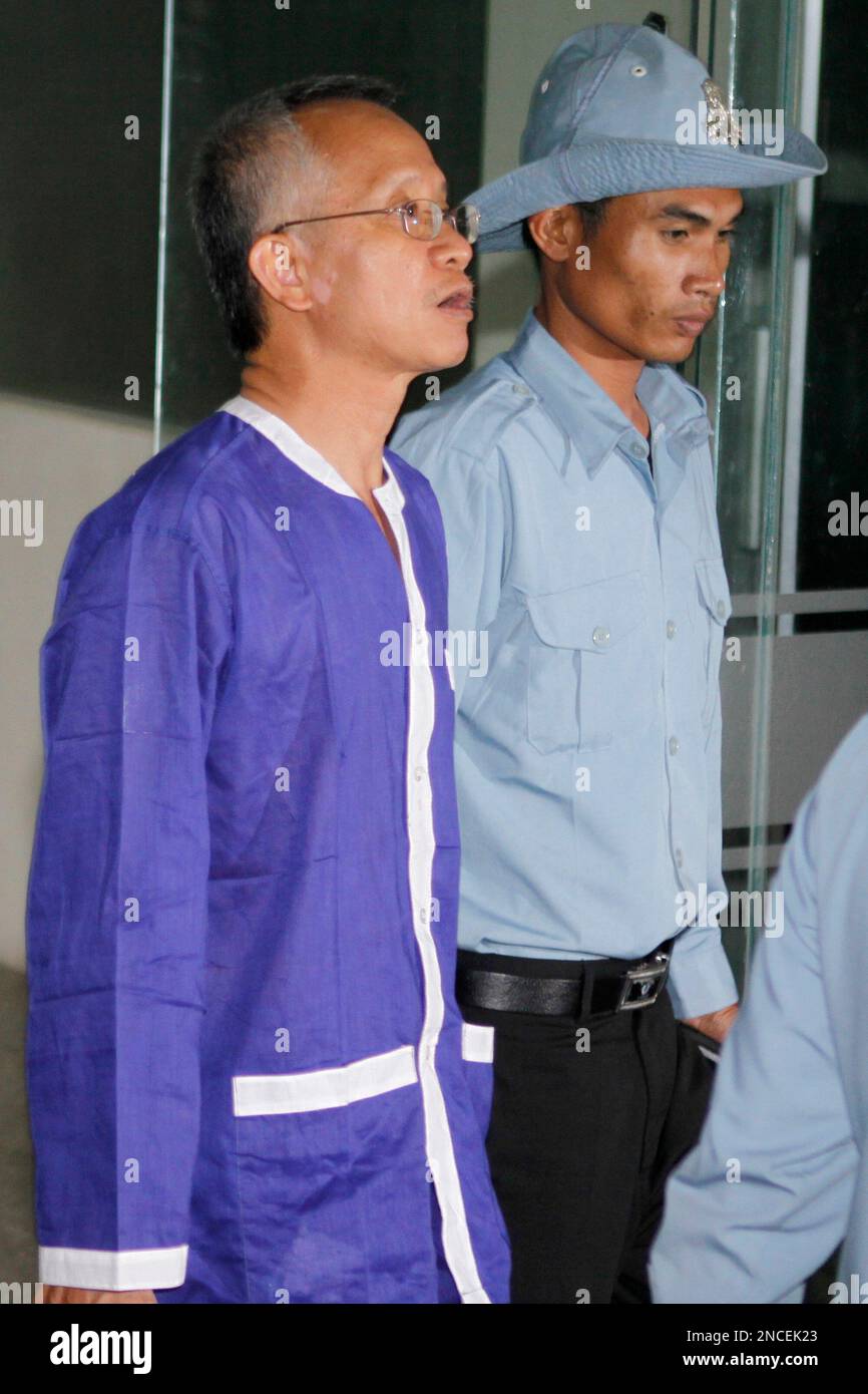 Thai activist Veera Somkwamkid, left, is escorted by Cambodian court security personnel at Phnom ...