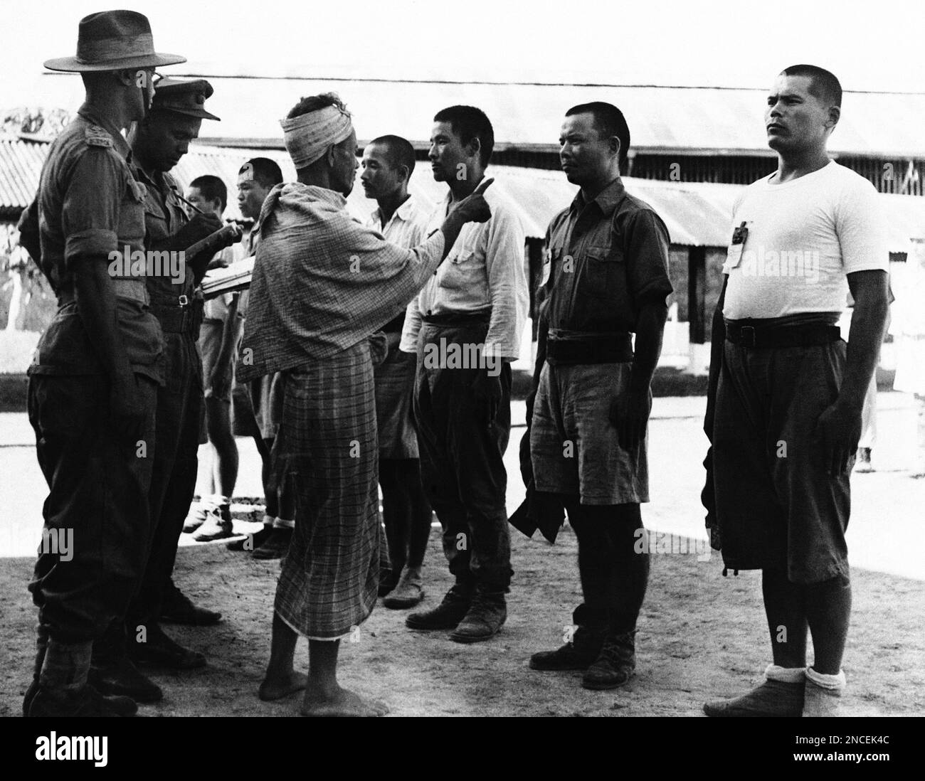 A survivor of the Kalagon Village, Burma, pointing out one of the ...