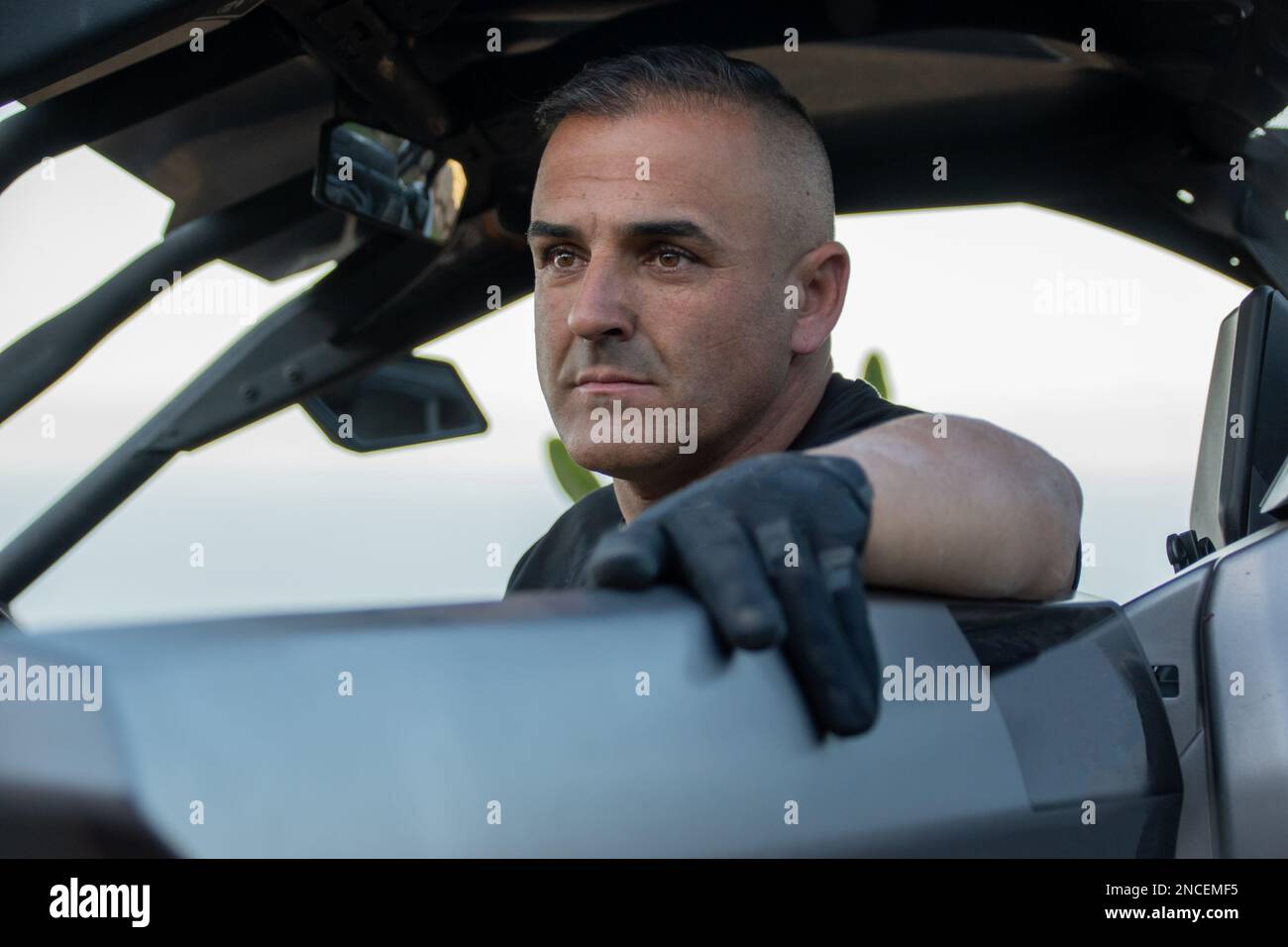 Close-up of a buggy driver getting out of the cockpit. He looks tired ...